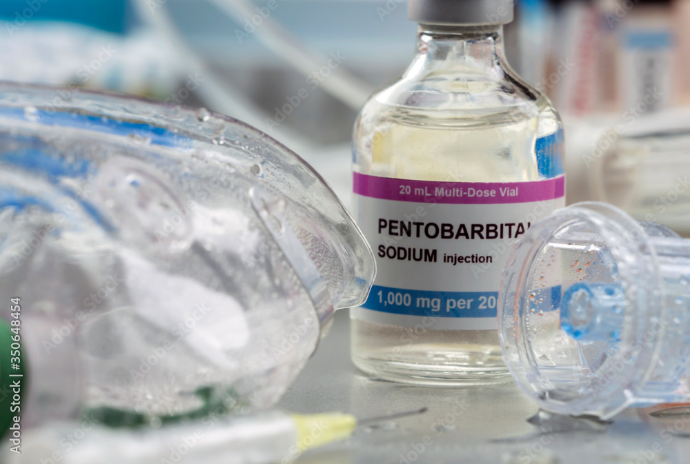 Vial of sodium pentobarbital next to an oxygen mask, covid-19 pandemic ...