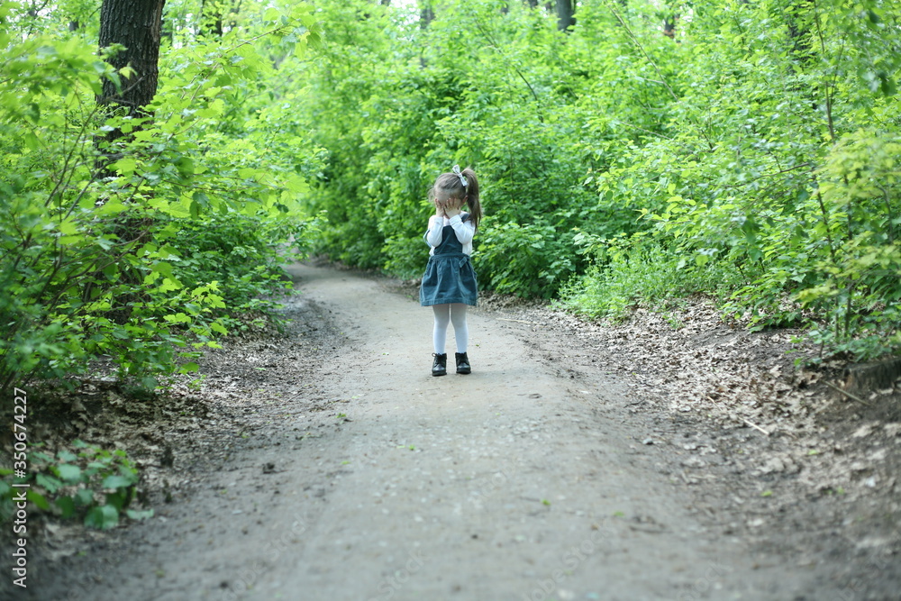 Offended girl.Тhe little girl was lost alone in the forest. Child alone ...