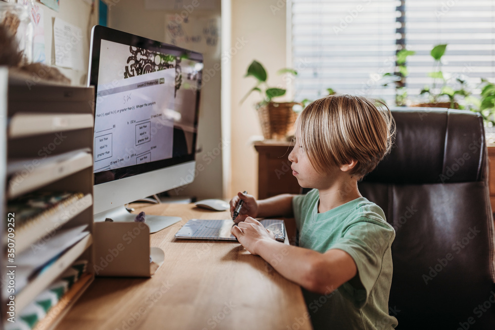Side view of school aged boy learning from teacher conducting class ...