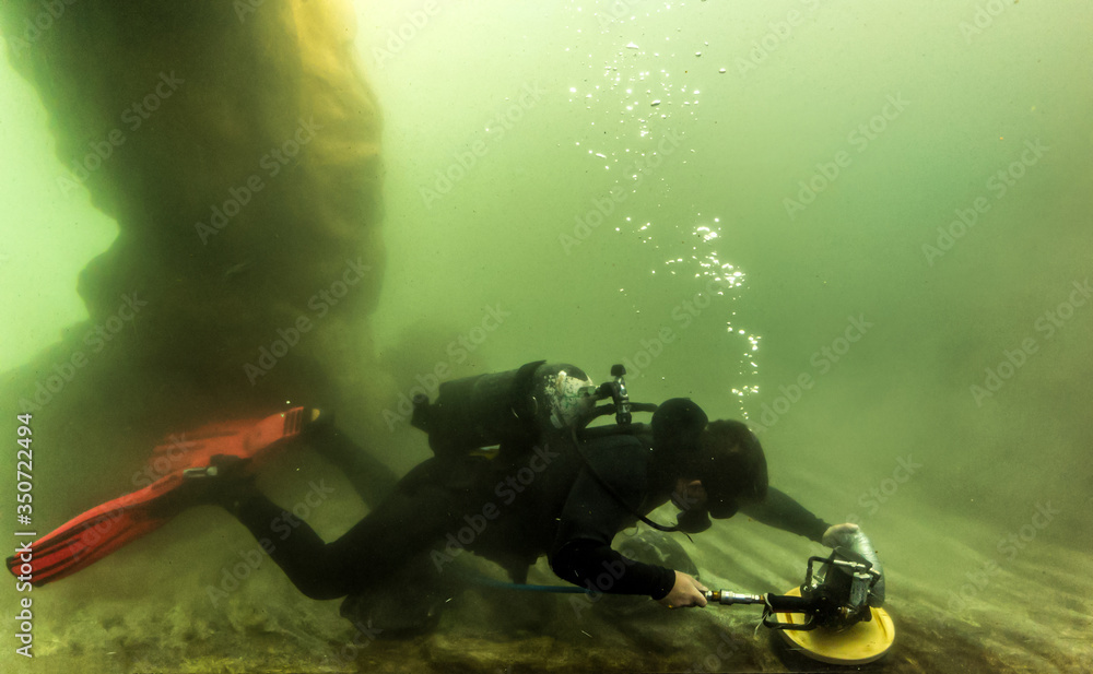 Proffesional diver clean a tank on the Aquarium. Stock Photo | Adobe Stock