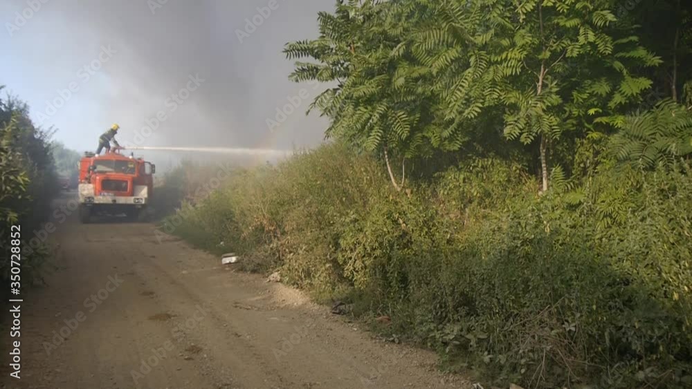 firefighter with fire extinguish, a firefighter in a firefighting ...