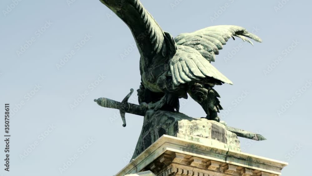 Bronze Turul bird statue at the gates of Buda Castle on a clear summer ...