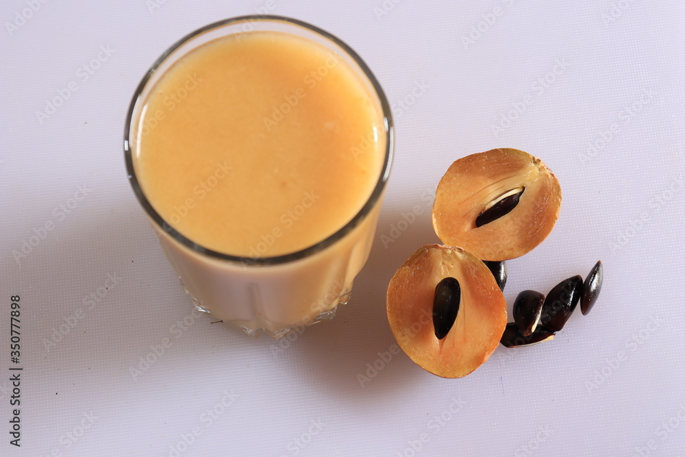 Ripe fresh whole and half of sapota fruit isolated on white background ...