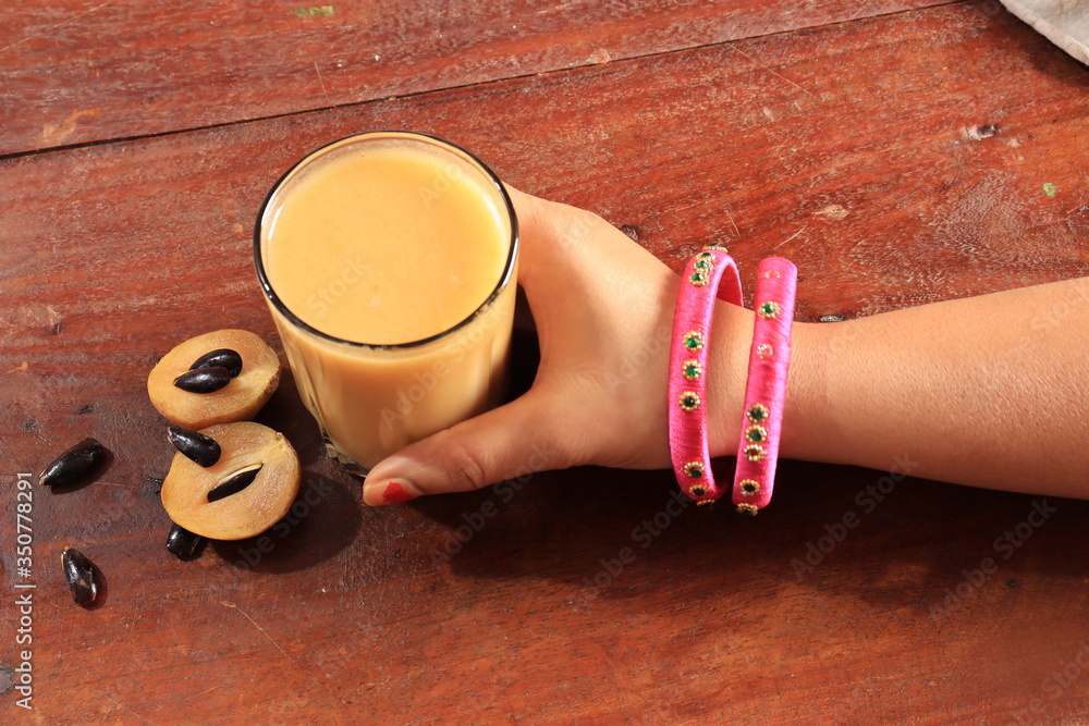 Ripe fresh whole and half of sapota fruit isolated on white background ...