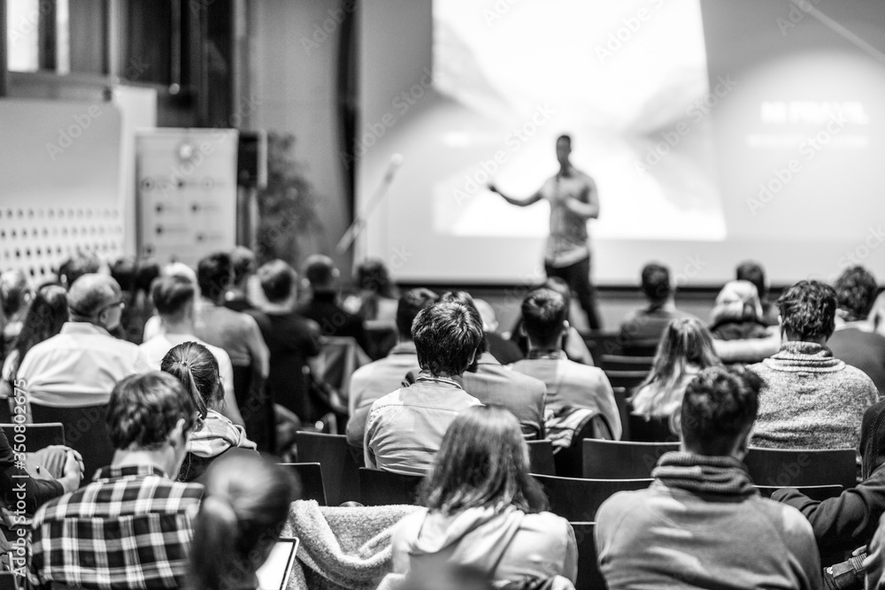 Speaker giving a talk in conference hall at business event. Audience at ...