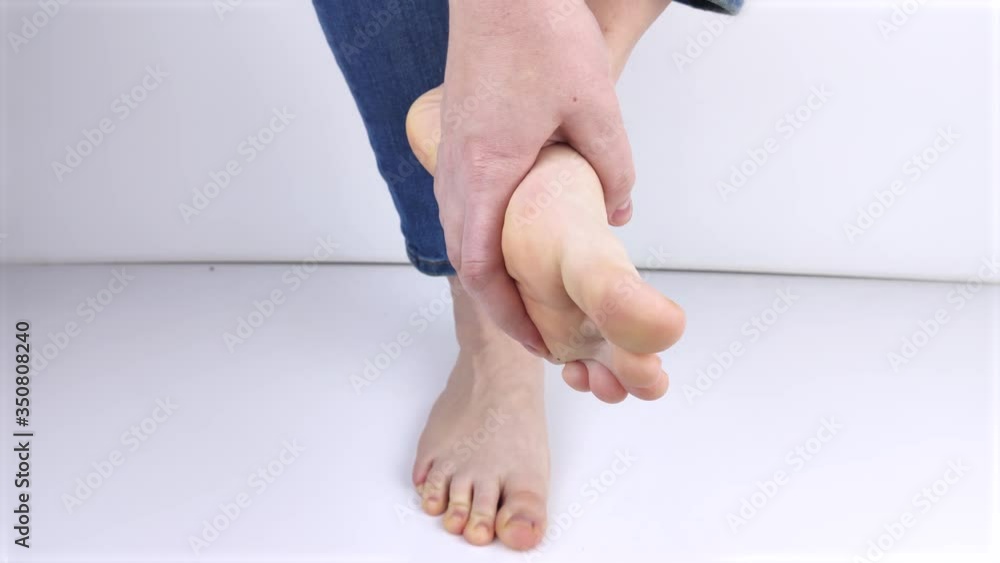 An orthopedic doctor examines a woman's leg. Heel pain, tendon ...