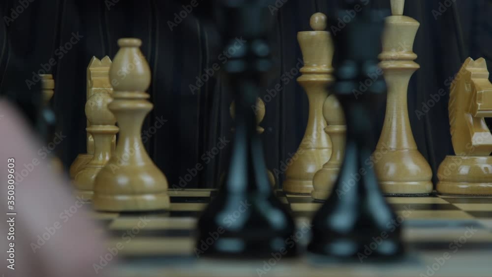 senior man hands put black chess pieces and arrange white chess figures ...