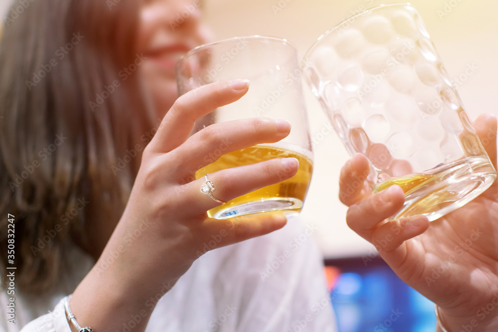 Couple making a toast with glass in hands to celebrate their marriage ...