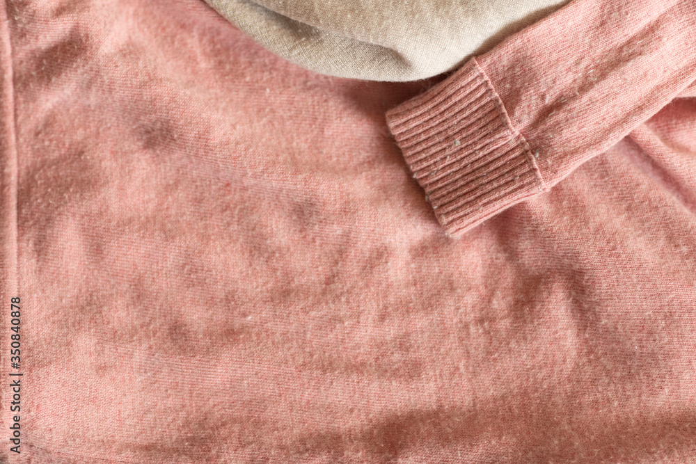 Old clothes in pink shades. Worn pieces with pills and fluffs in ...