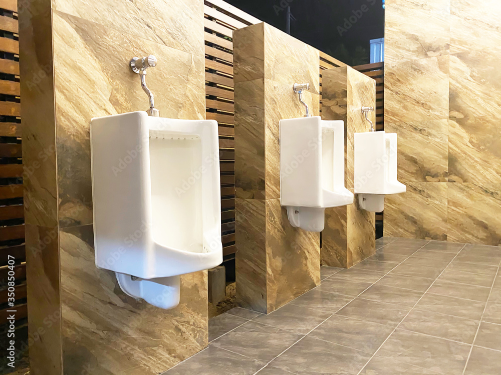 Men's white urinals design, Close up row of outdoor urinals men public ...