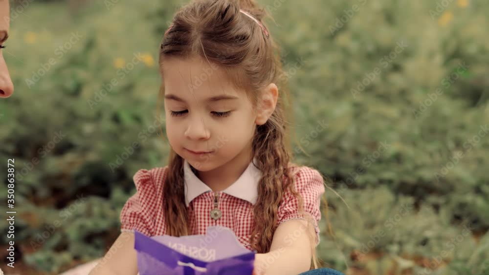 Wideo Stock: Daughter With Cheerful Mother Eat Candy.Happy Beautiful ...
