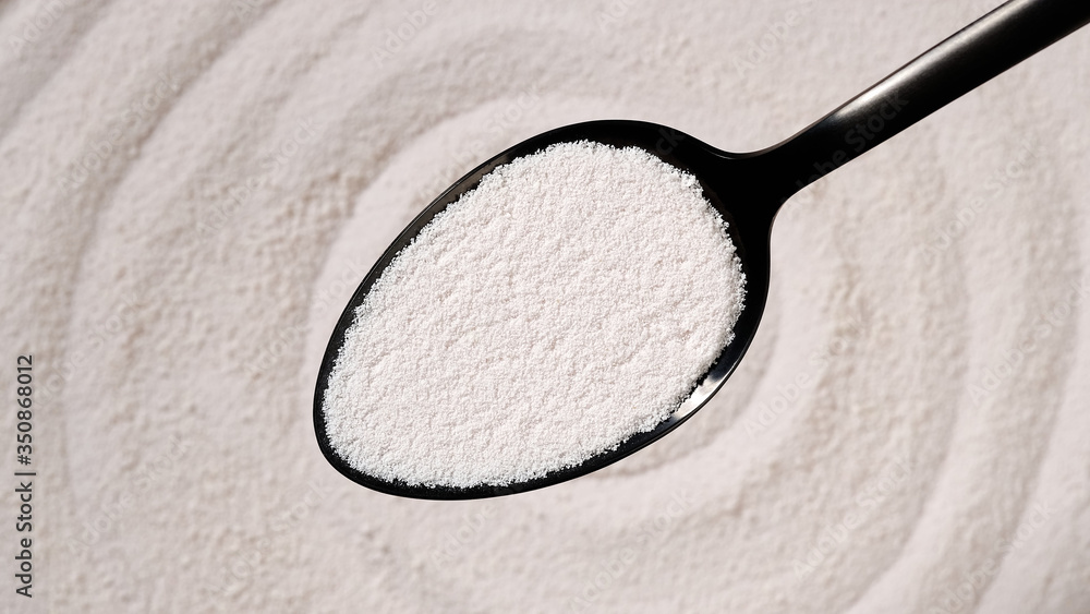 collagen powder in black spoon and collagen powder background. Natural ...