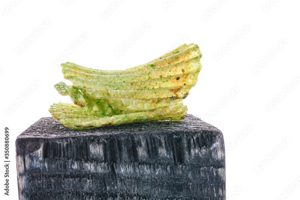 Potato crisps with crincle cut and hot wasabi flavouring taste isolated ...