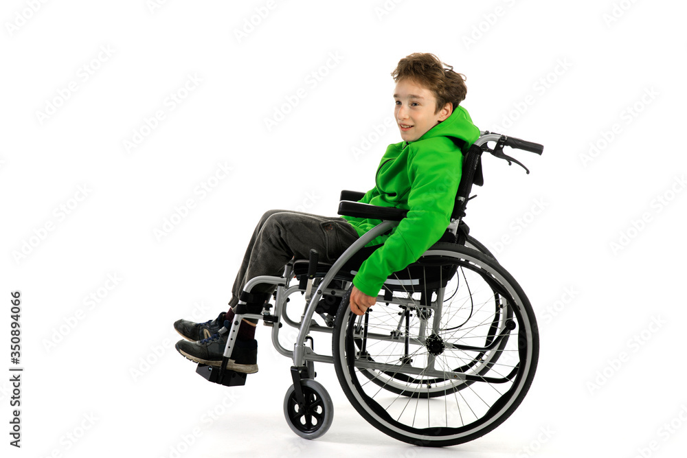 Little boy in wheelchair on white background , boy is sitting in a ...