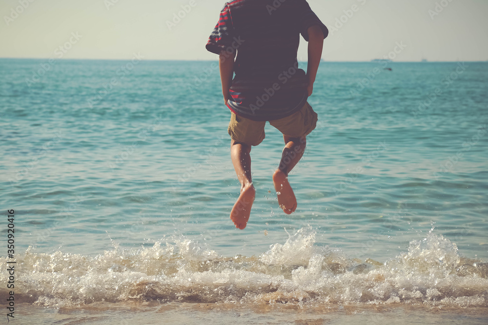 young boy jumping on the beach in miami south beach Stock Photo | Adobe ...