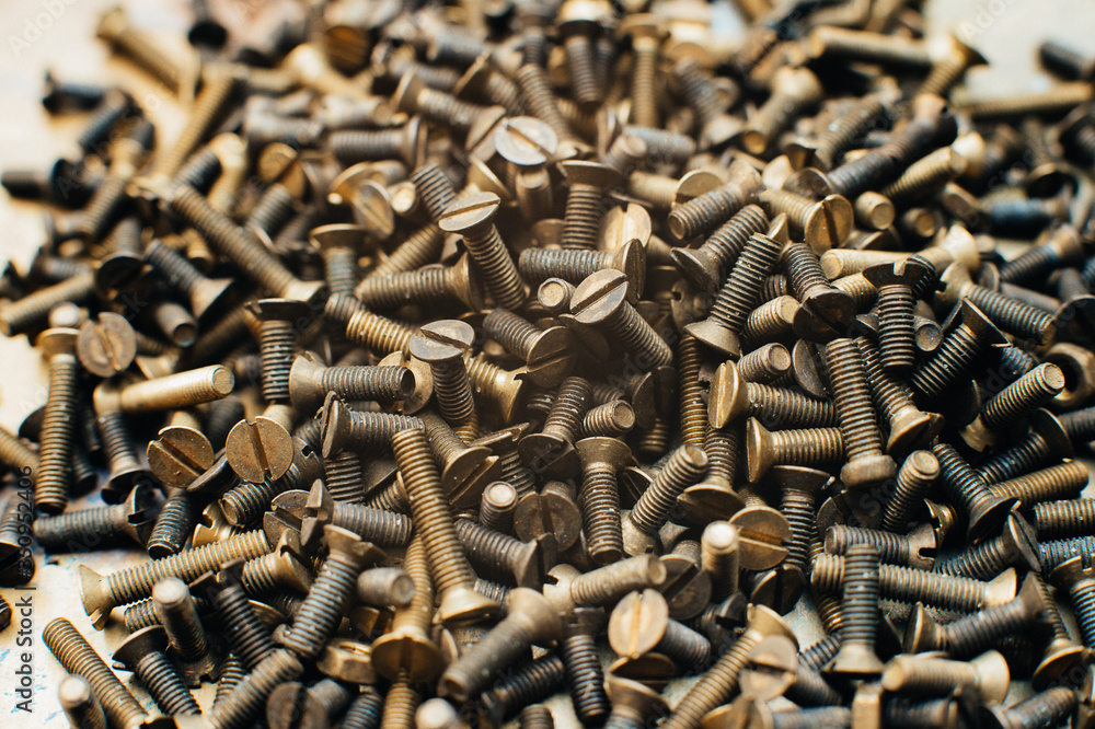 Close-up, macro. Old Soviet brass countersunk head screws with a flat ...