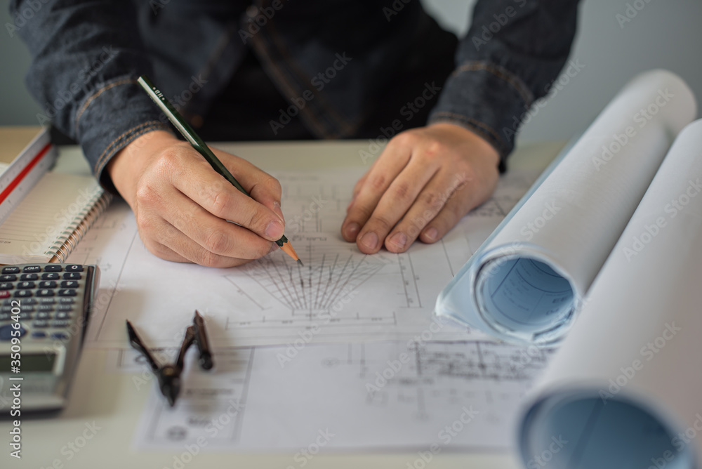 Architect working on blueprint. Architects workplace - architectural ...