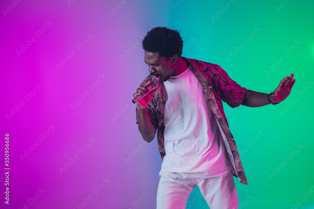 African-american male singer portrait isolated on gradient studio ...
