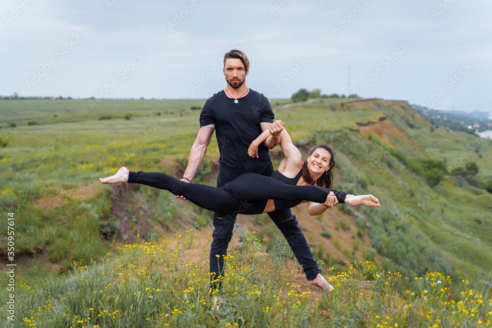 Foto de Acrobats. Yoga. Gymnastics. Strong, muscled attractive athlete ...