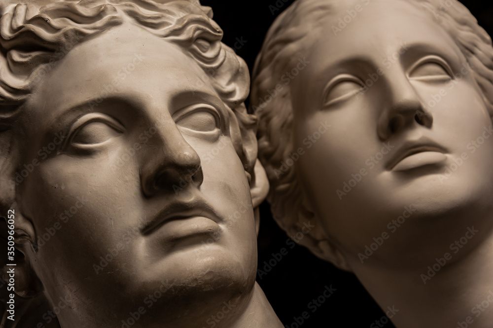 Group gypsum busts of ancient statues human heads for artists on a dark ...