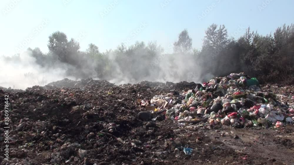 Extinguished fire in the dump, no open flames, smoke rises from the ...