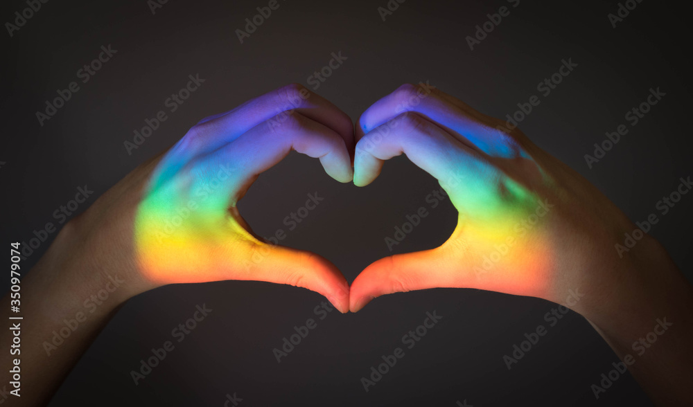 Hands making a heart sign with the colors of the lgbt rainbow flag ...