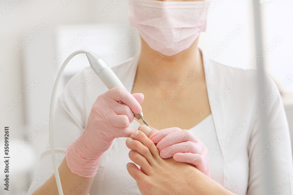 Patient on medical pedicure procedure, visiting podiatrist.Professional ...