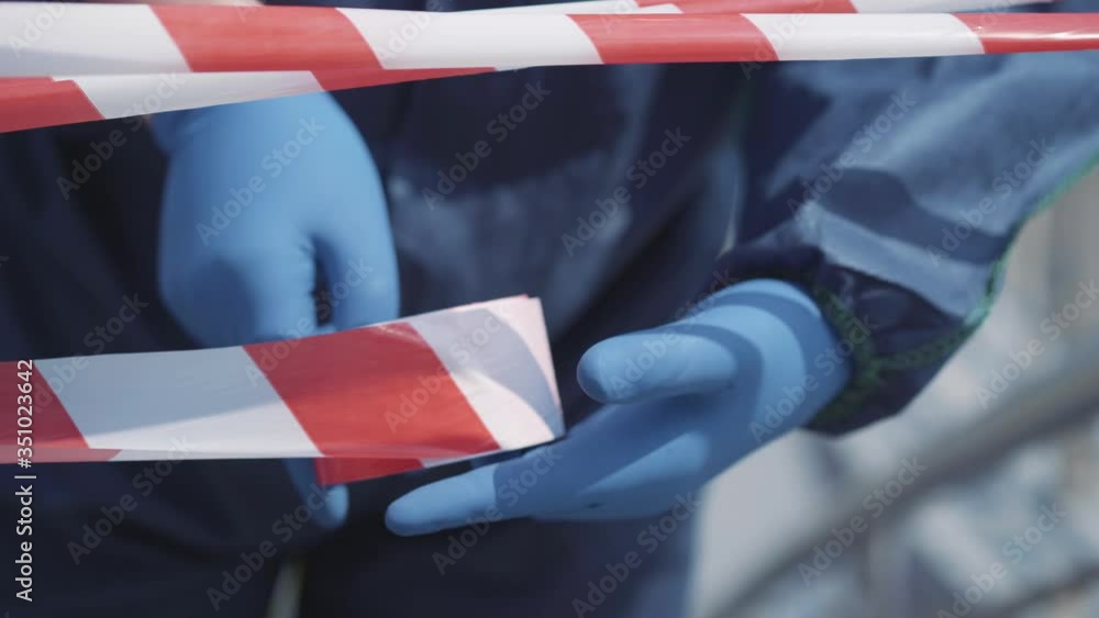 Camera moves along warning tape stretched by unrecognizable people in ...