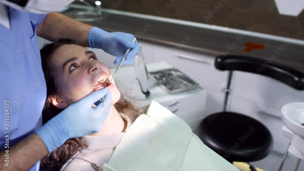 PAN with high angle of unrecognizable male dentist in scrubs and gloves ...