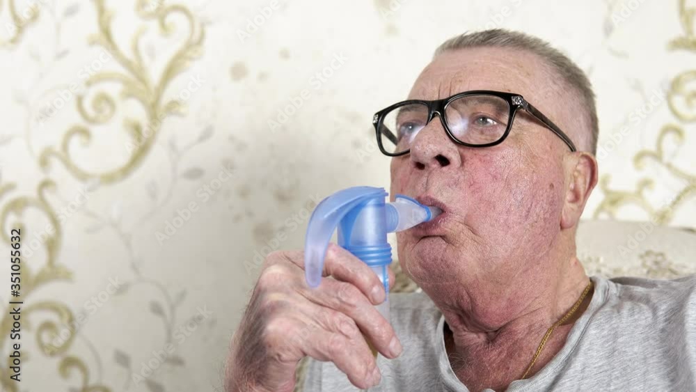 Old grandfather makes medical steam inhalations at home. Theme of a ...