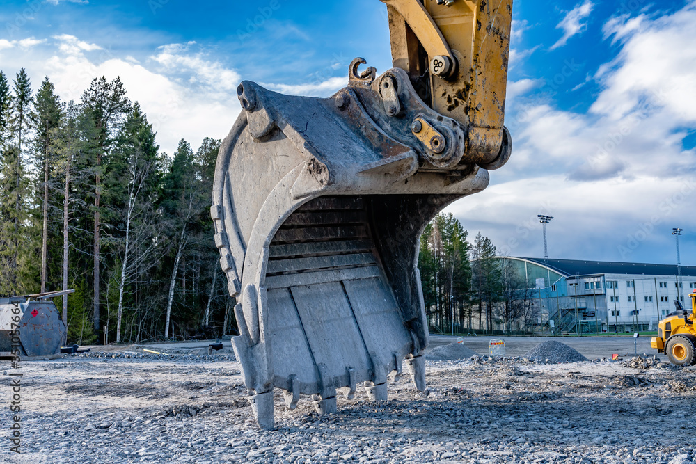 Close up side view at beautiful large excavator's scoop on new not yet ...