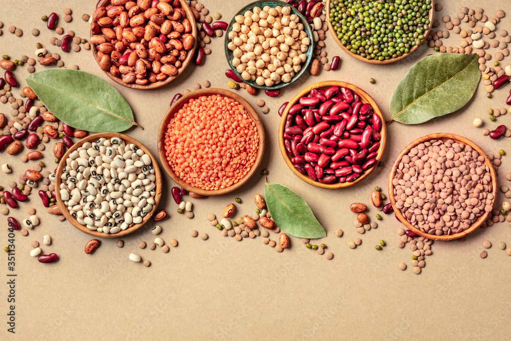 Legumes assortment, shot from the top on a rustic brown background with ...