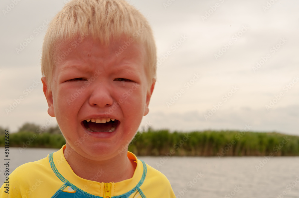 Blond boy is crying with tears. Upset baby. Domestic violence against ...