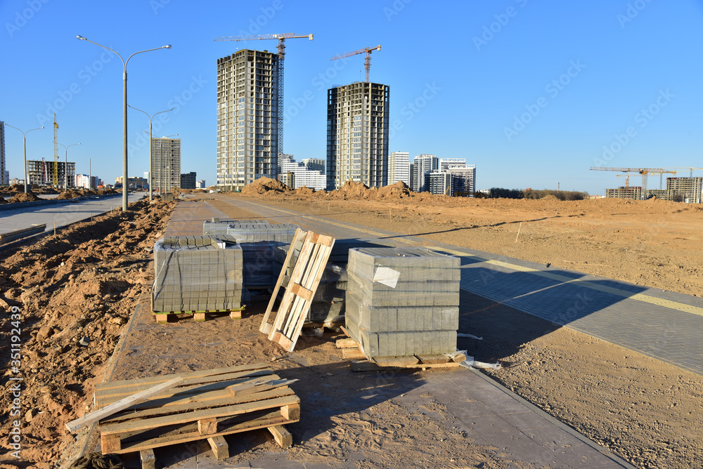 Laying paving slabs and borders at construction site. Process of ...