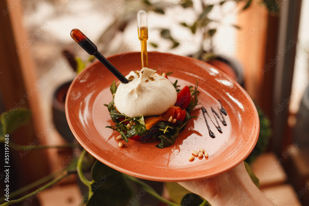 caprese salad with mozzarella inserted pipettes with olive oil and ...