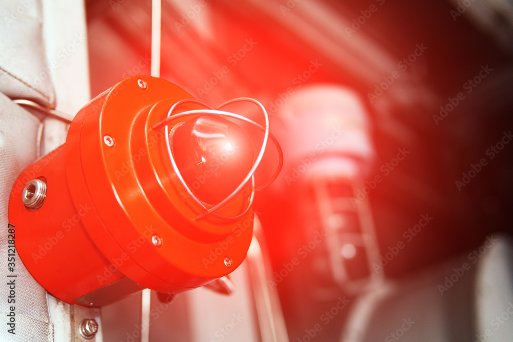 Fire alarm with red warning light of an emergency beacon at an ...