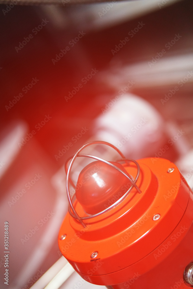Fire alarm with red warning light of an emergency beacon at an ...