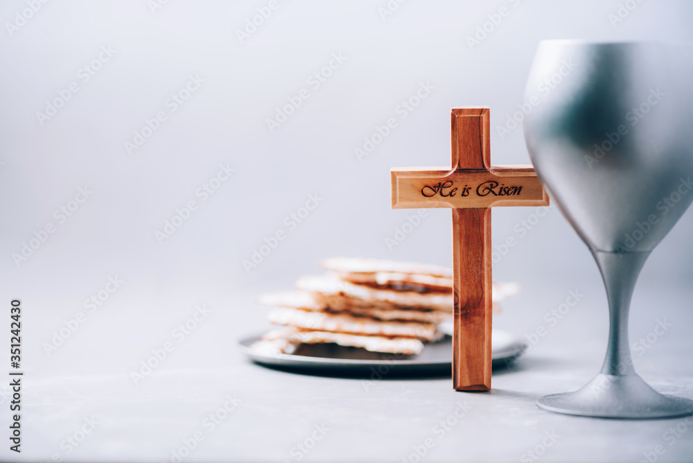 Matzos unleavened bread, chalice of wine, wooden cross on grey ...