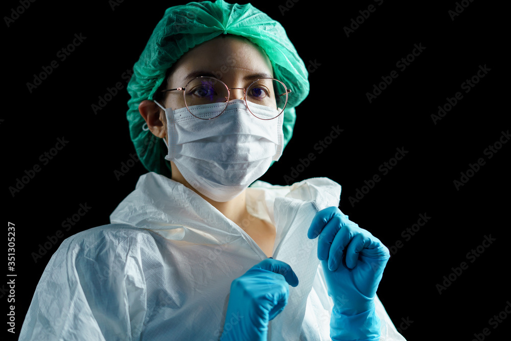 Medical worker taking off PPE (personal protective equipment) wearing ...