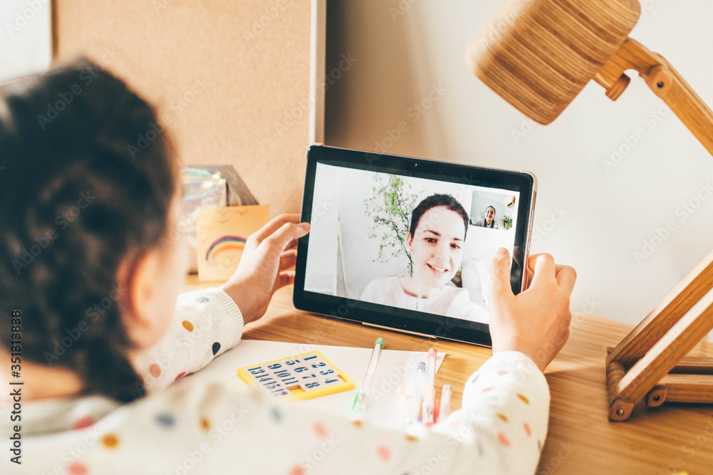 School girl having video call with teacher using webcam at home. Online ...