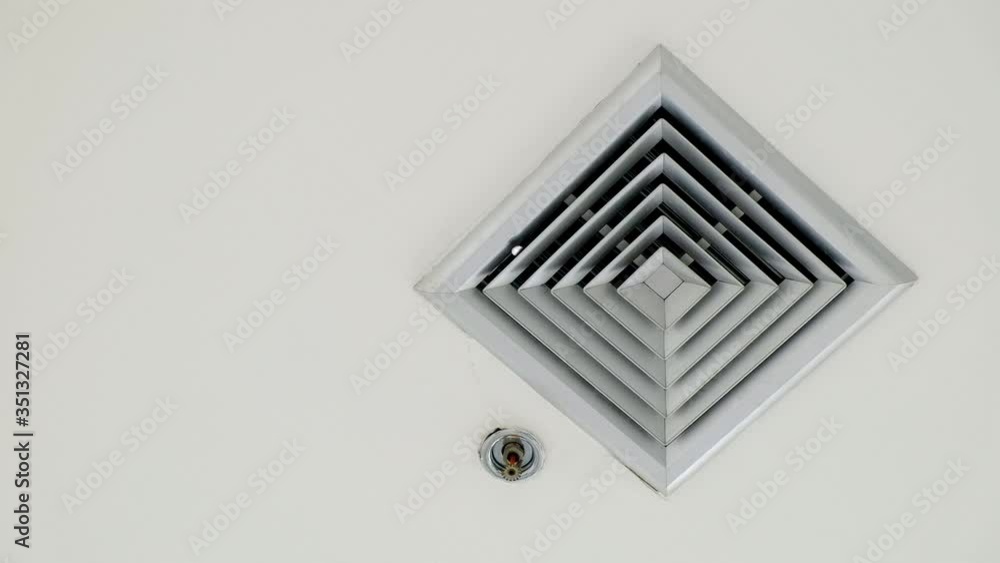 Air vent on a ceiling, pans to air vent cover on office ceiling ...