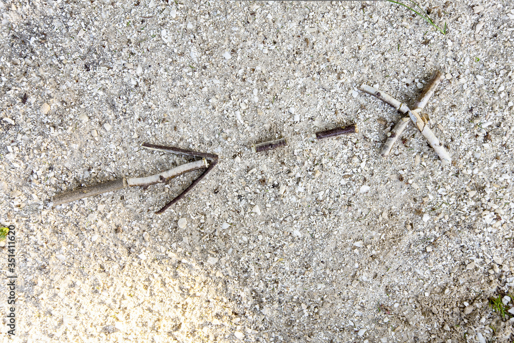Wooden stick arrow sign at forest white gravel stone path. Scavenger ...