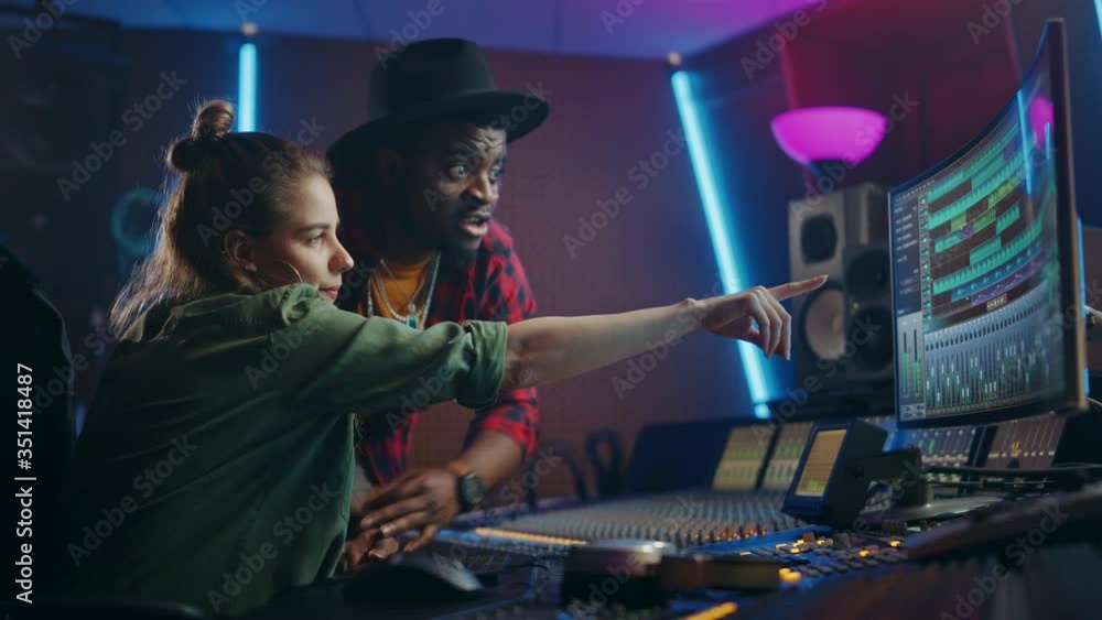 Handsome Male Producer and Professional Audio Engineer Working together ...