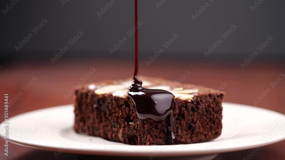 Chocolate pouring on cake in 4K Resolution. Topping chocolate on ...