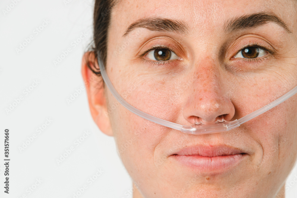 Sick female patient with a nasal cannula Stock Photo | Adobe Stock