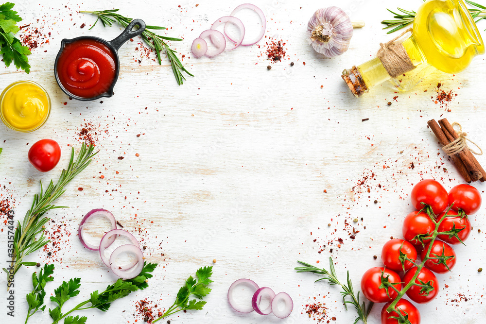 White wooden background of cooking. Spices and vegetables. Top view ...