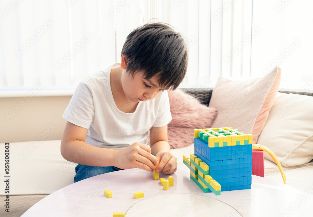 School kid using plastic block counting number,Child boy studying math ...