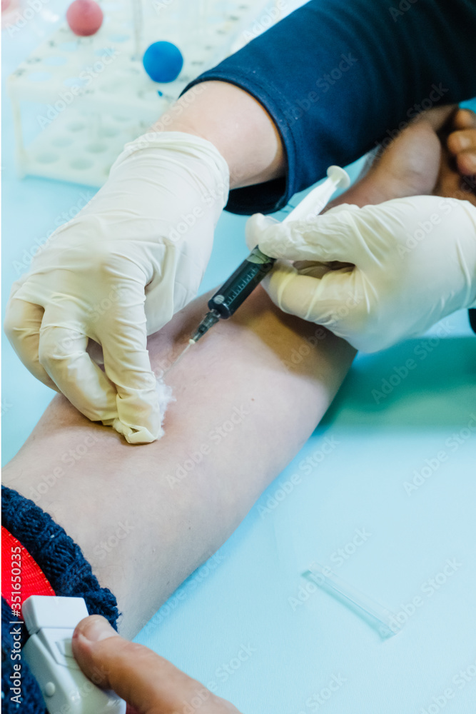blood sampling from a vein, drops of blood appeared on his hand ...