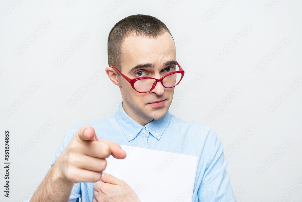 Teacher man looks reproachfully at the camera and points a finger at ...