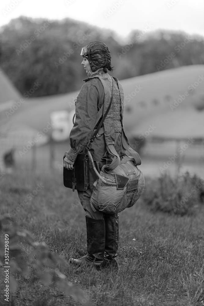 Retro style black and white. A young female pilot in uniform of Soviet ...